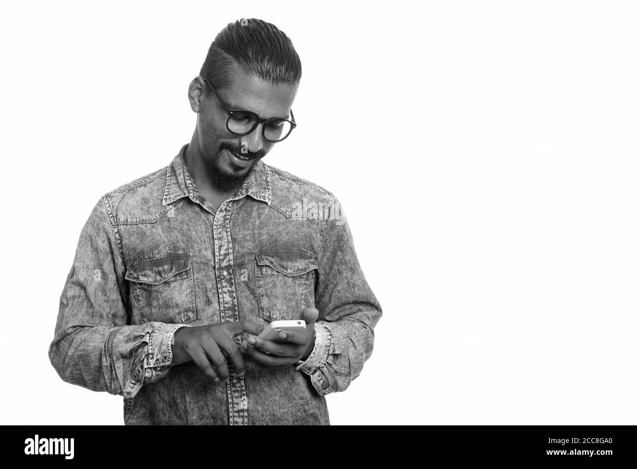 Young happy Indian man using mobile phone Stock Photo - Alamy
