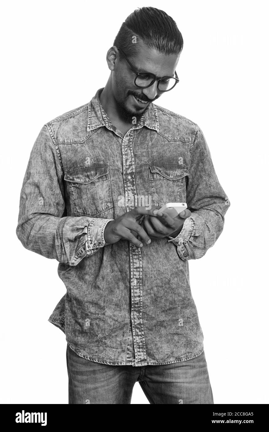 Young happy Indian man using mobile phone Stock Photo - Alamy