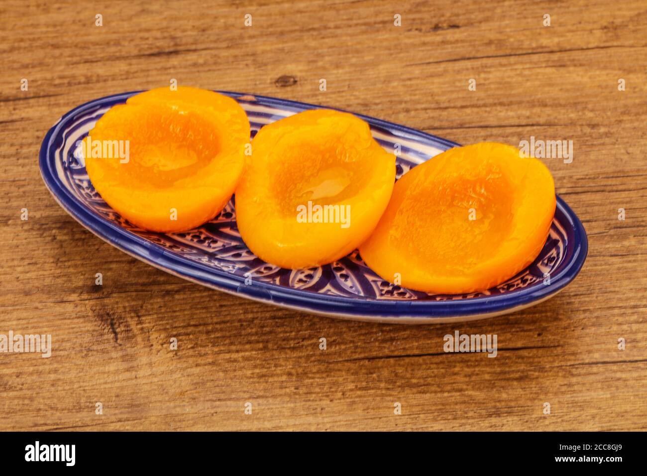 Marinated peaches fruit in the bowl with syrope Stock Photo - Alamy