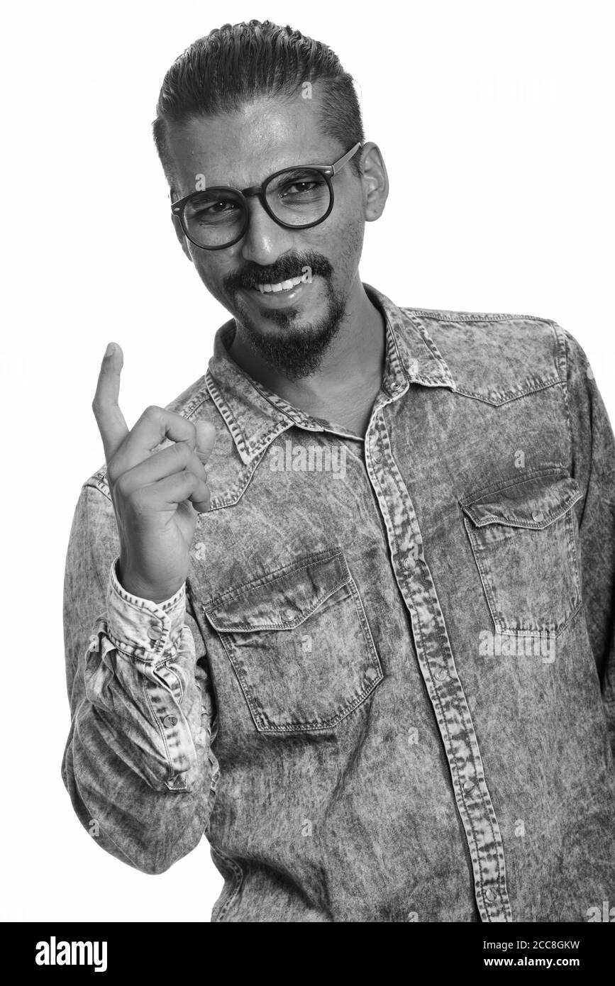 Young happy Indian man pointing finger up Stock Photo - Alamy
