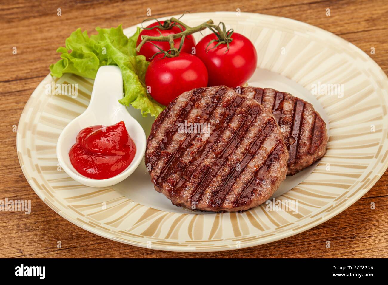 Grilled burger cutlet with tomato sauce Stock Photo - Alamy