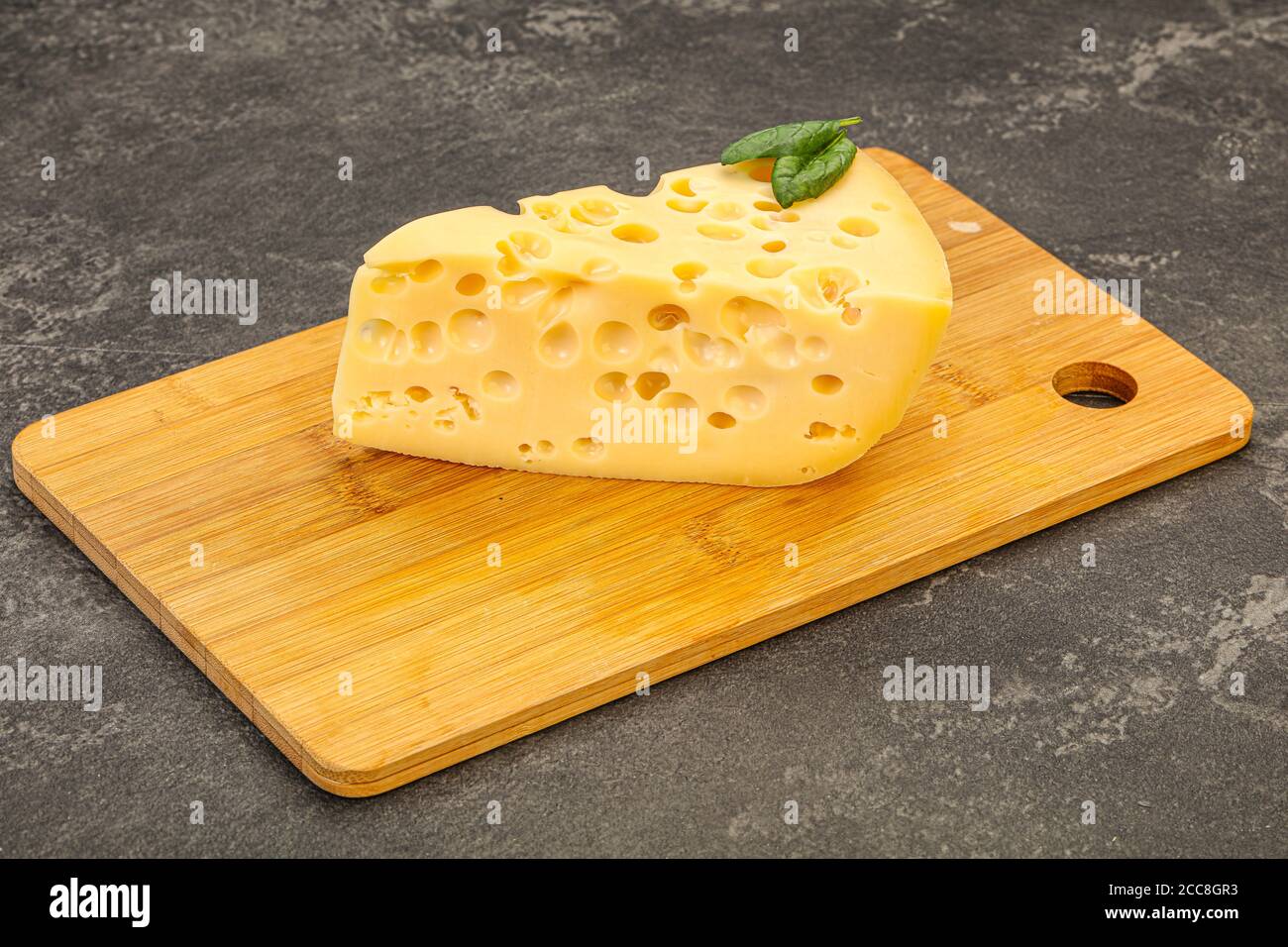 Maasdam cheese - dairy yellow triangle with holes Stock Photo - Alamy