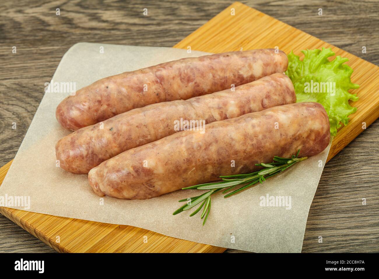 Raw pork meat sausages for grill served rosemary Stock Photo - Alamy
