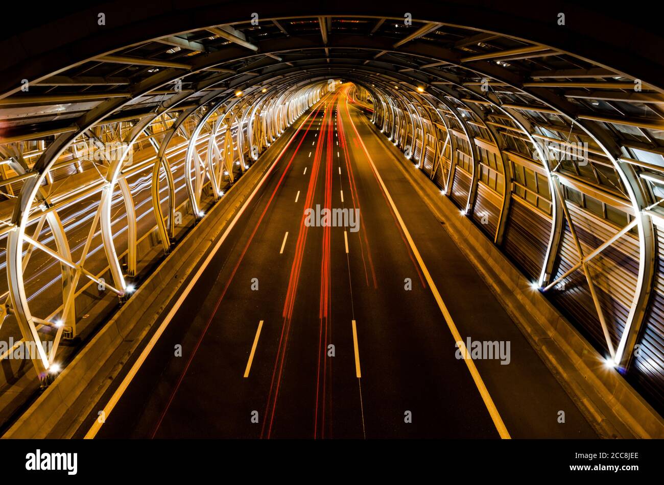Multiple line highway ground-based glass tunnel. Speed lines from cars ...