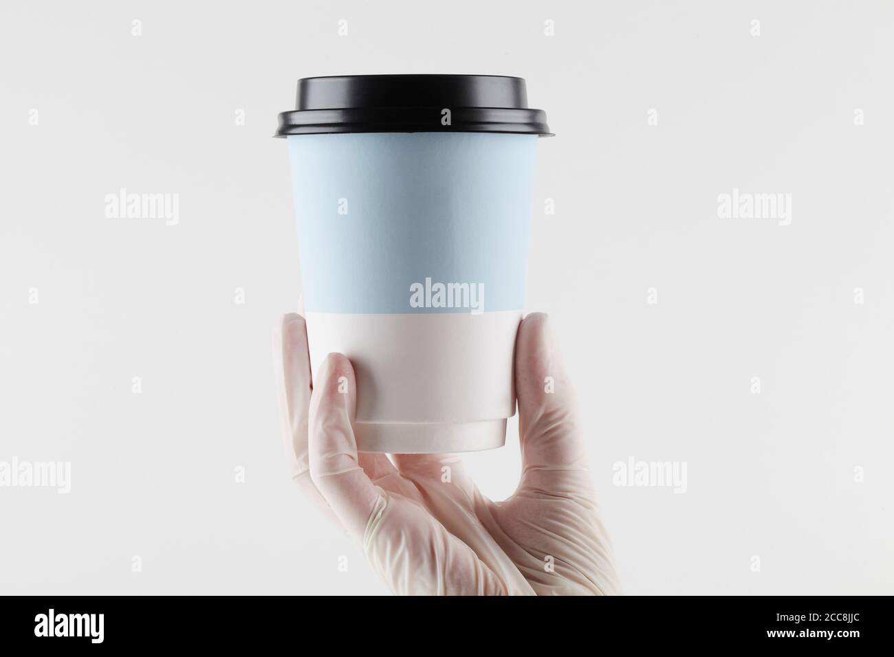 Mockup of human hand in white gloves holding take away paper cup for ...