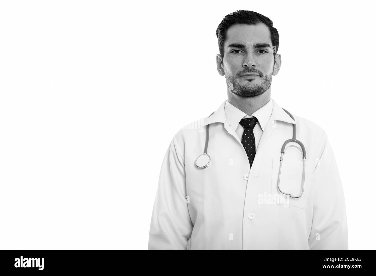 Studio shot of young handsome man doctor Stock Photo - Alamy