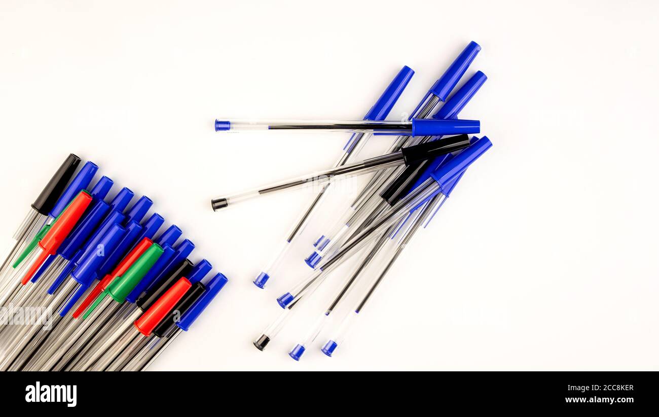 Pile of a lot multi colored plastic ballpoint pens on white background ...
