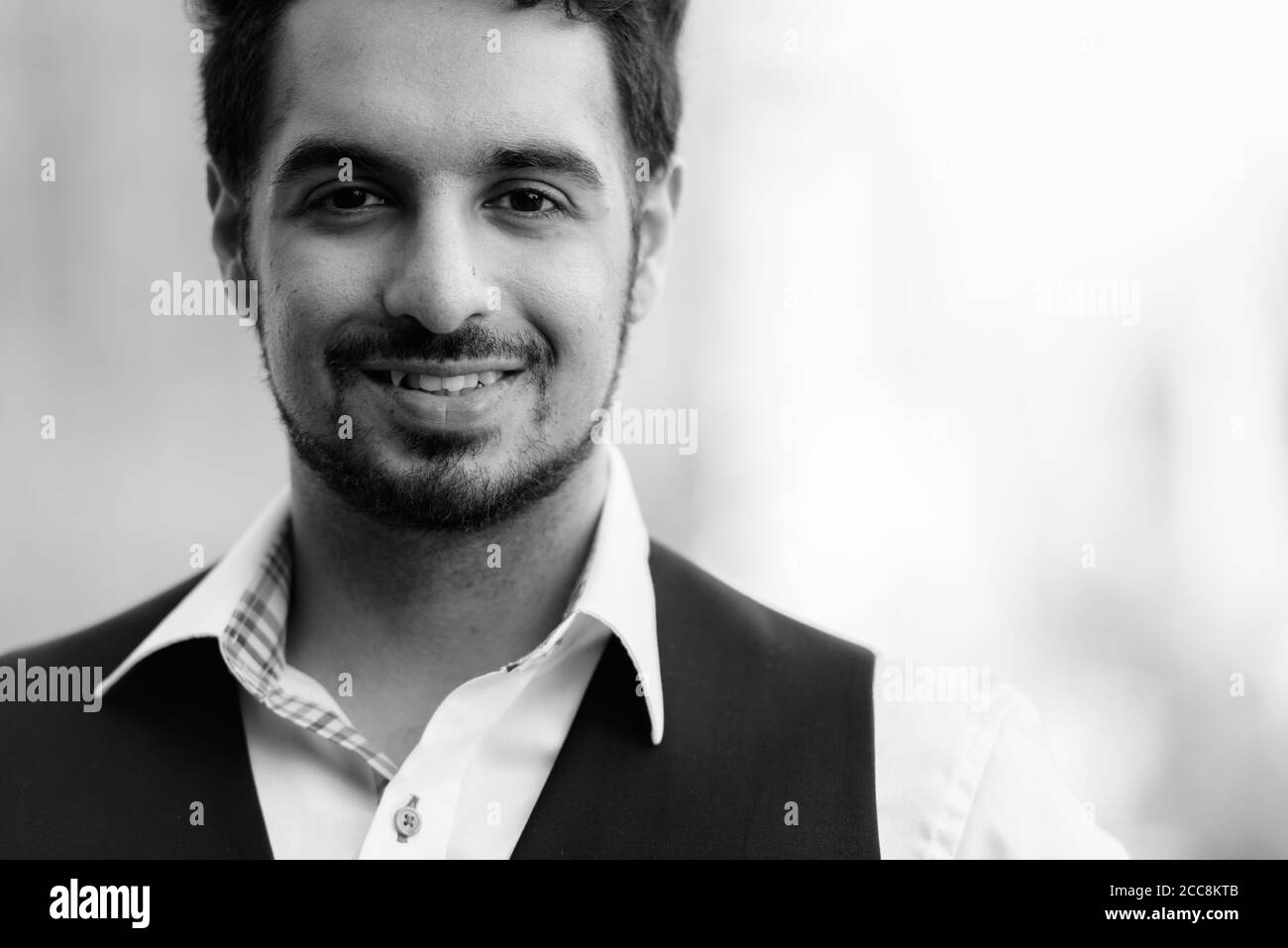 Close up of young happy Indian man smiling outdoors in the city Stock ...