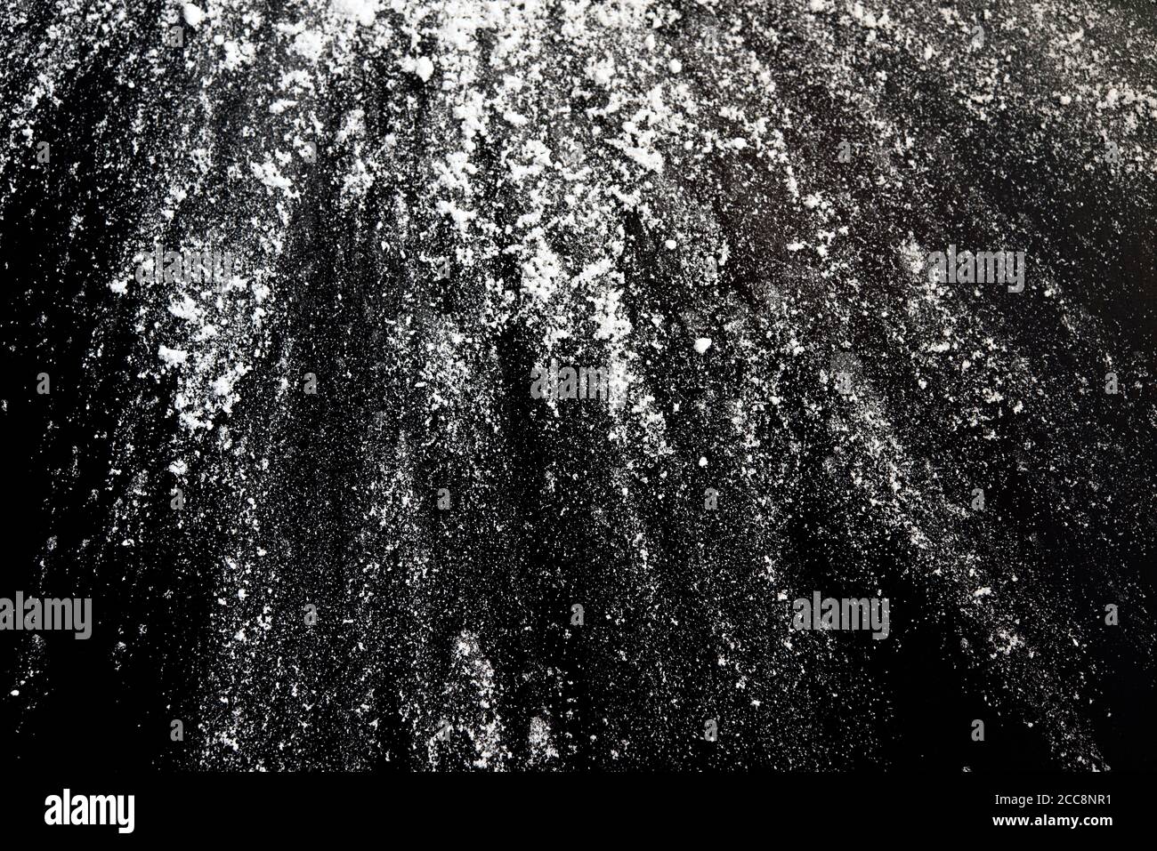 Flour on black background Stock Photo - Alamy
