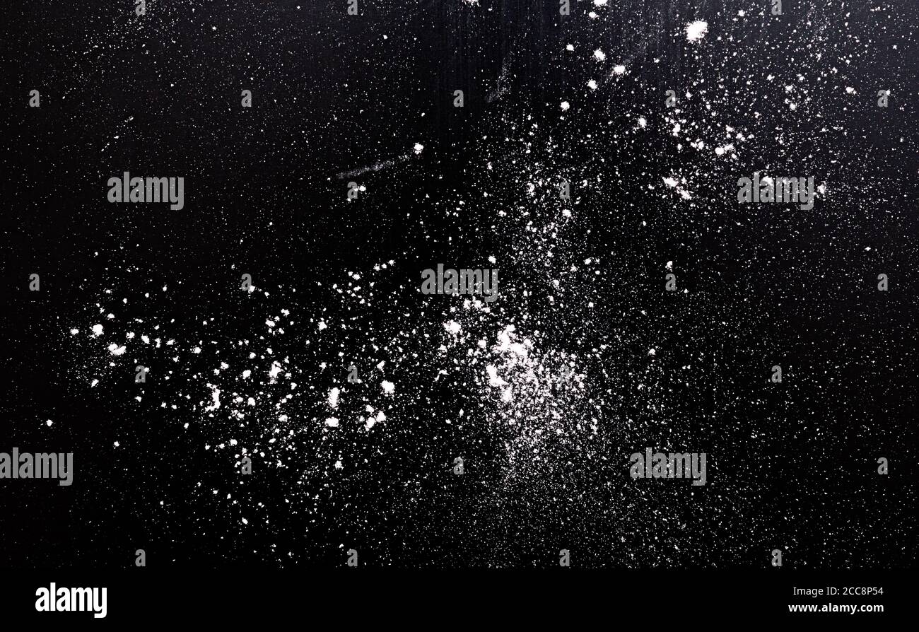 Flour on black background Stock Photo - Alamy
