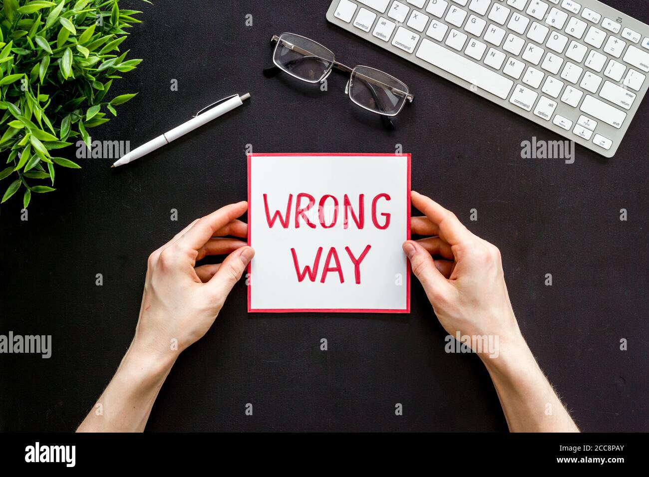 Business failure. Wrong way icon in hands on office desk top-down Stock ...