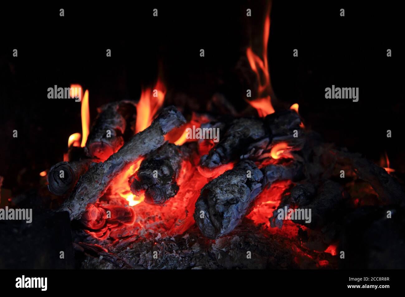 fireplace background (fire texture) in the dark Stock Photo - Alamy