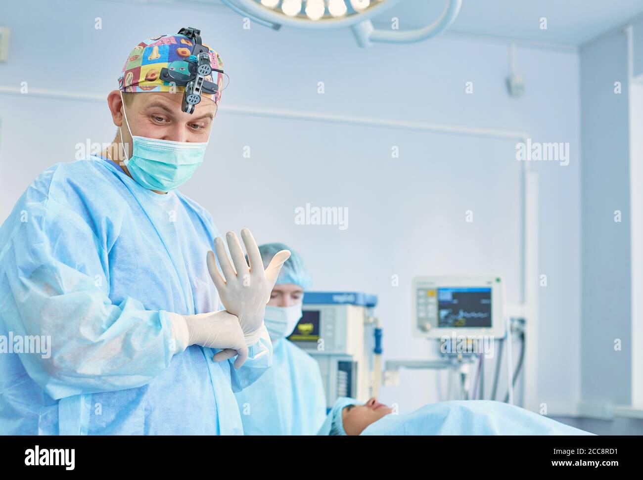 Several doctors surrounding patient on operation table during their ...