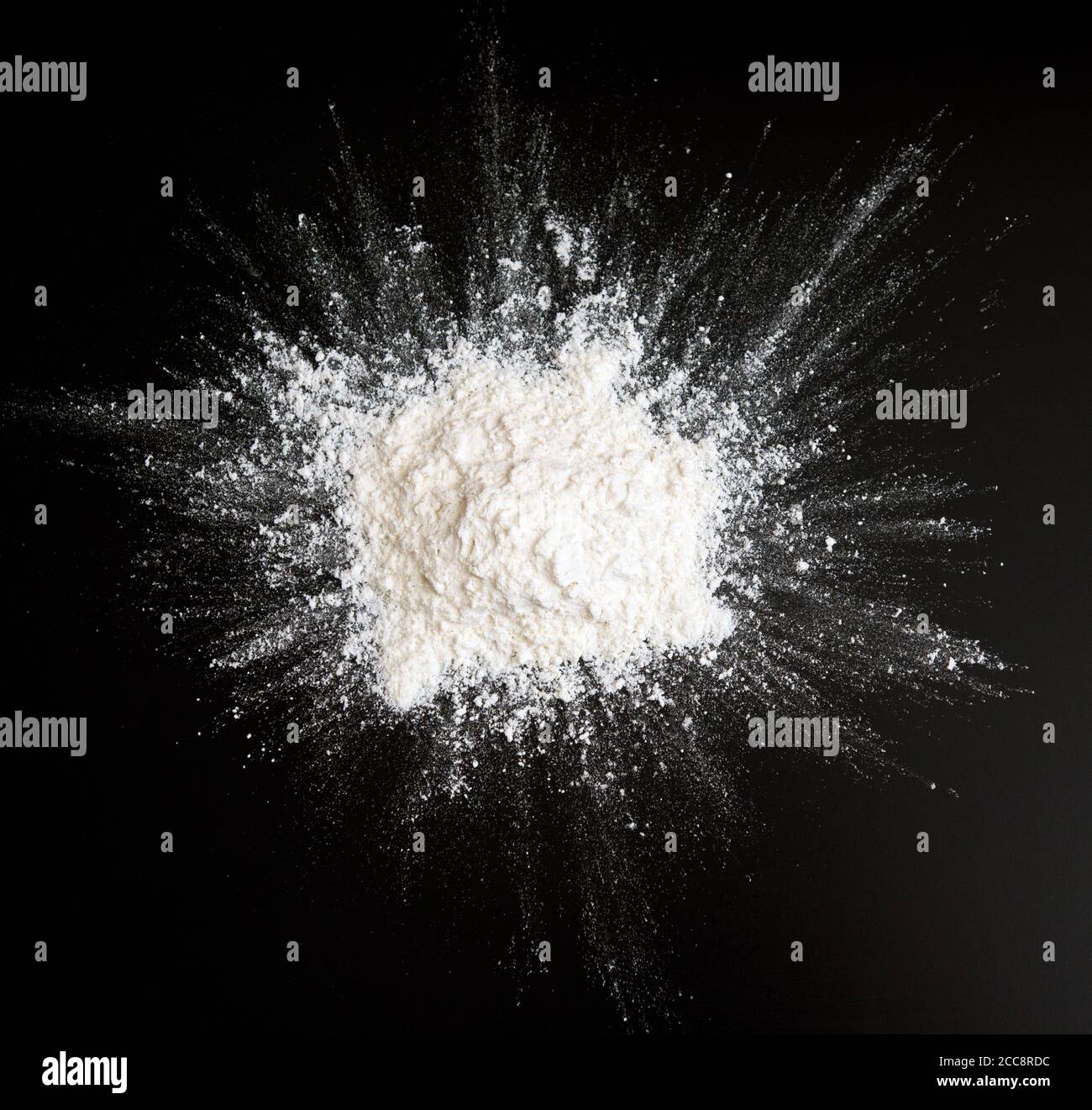 Flour on black background Stock Photo - Alamy
