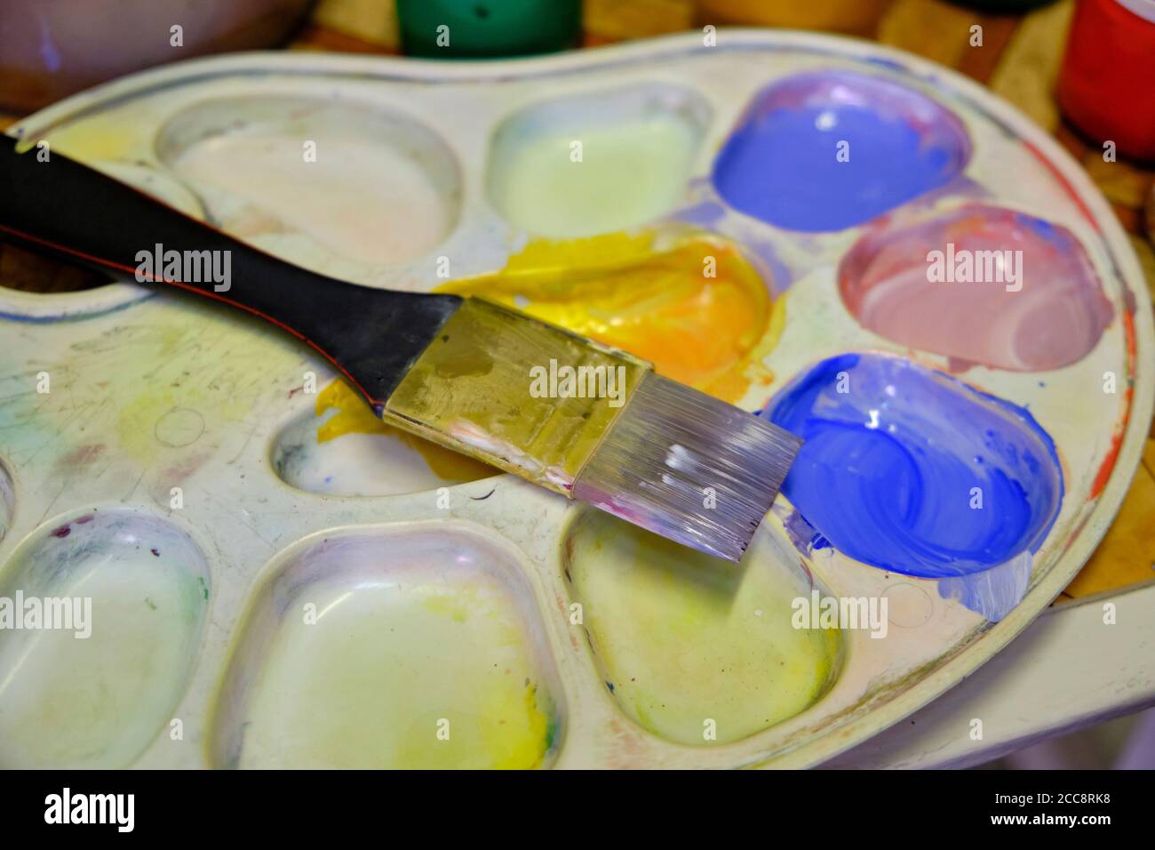 Paintbrush artist palette and multi colored gouache Stock Photo - Alamy