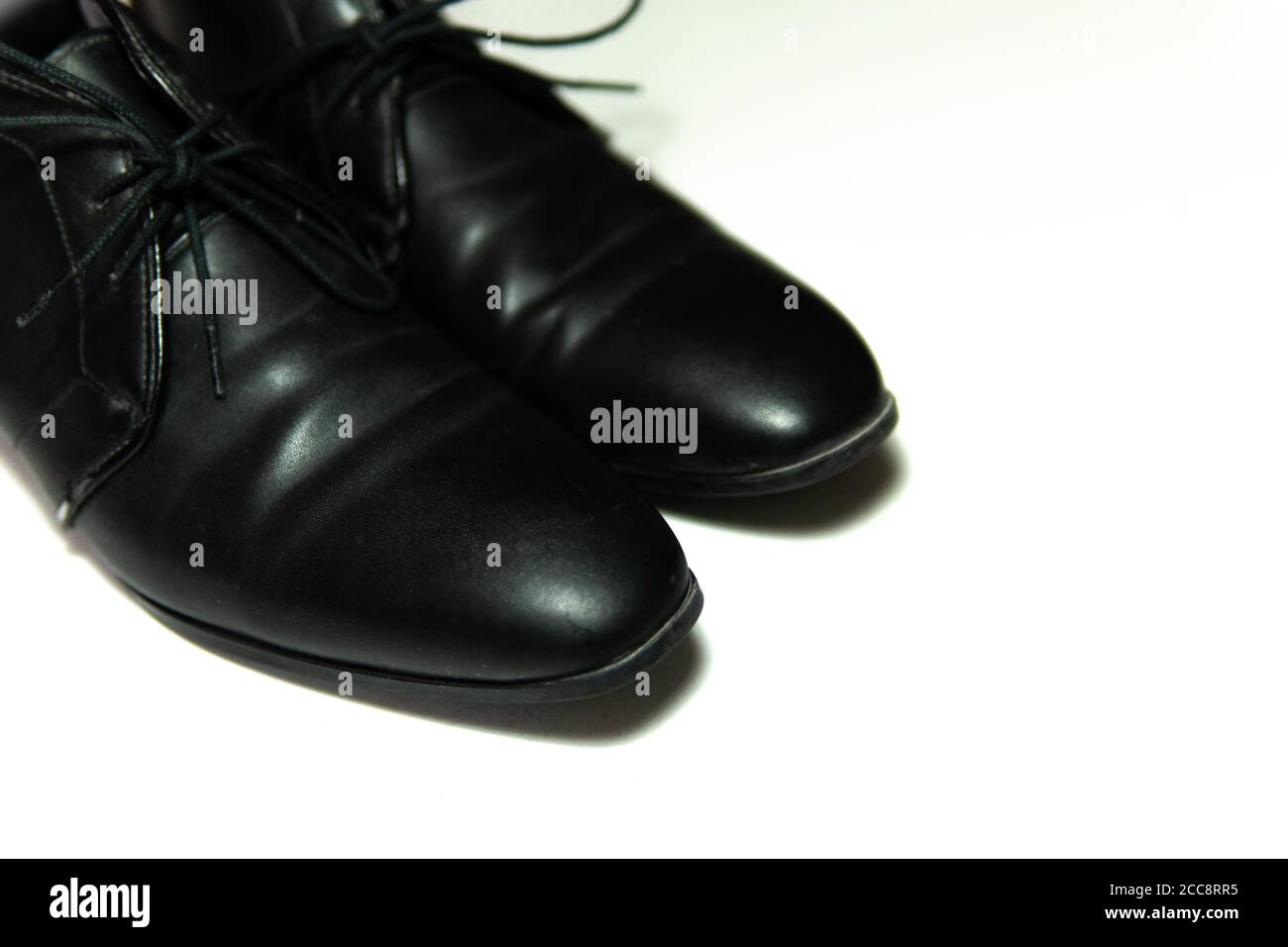 Closeup shot of black leather shoes for men on white background Stock ...