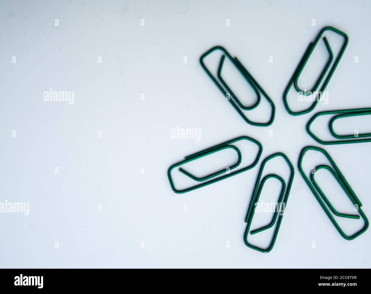 Top view shot of green clips on a white background Stock Photo - Alamy
