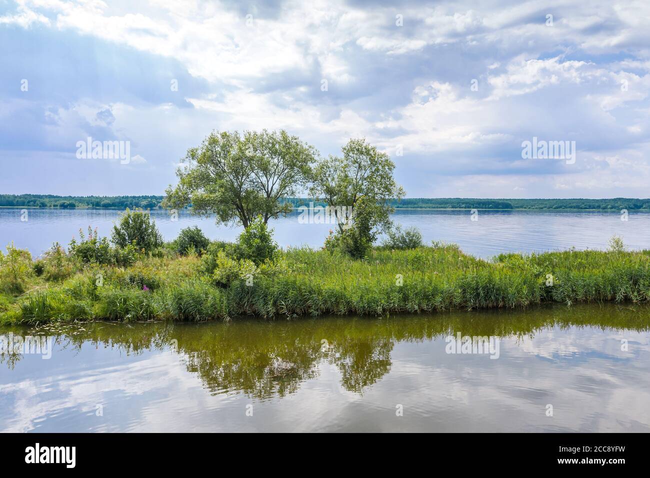 small island with green trees on Vileyka water reservoir, Belarus ...