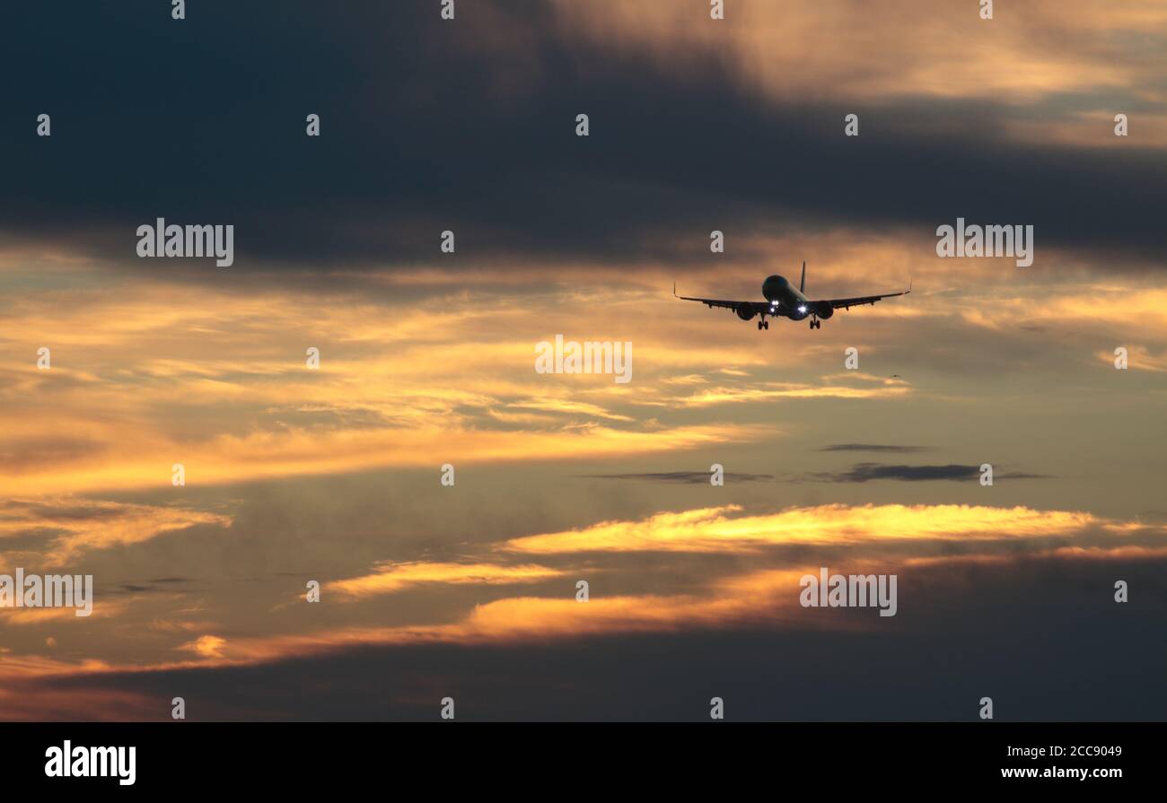 Silhouette passenger plane against sun hi-res stock photography and ...