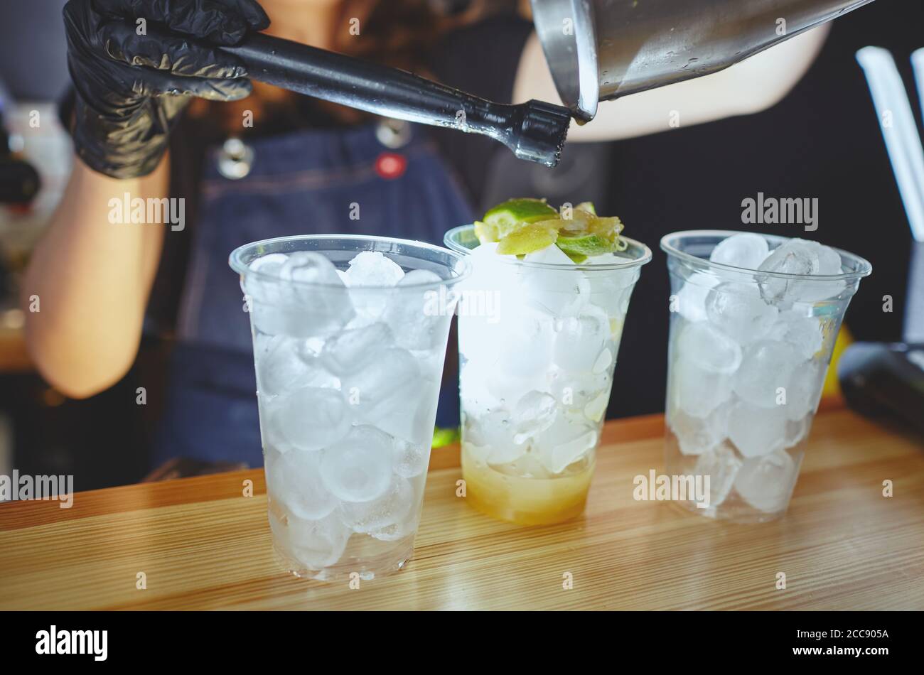 Bartender making mojito cocktail. Process of bartending in bar.Mint leaves,ice,lime ...