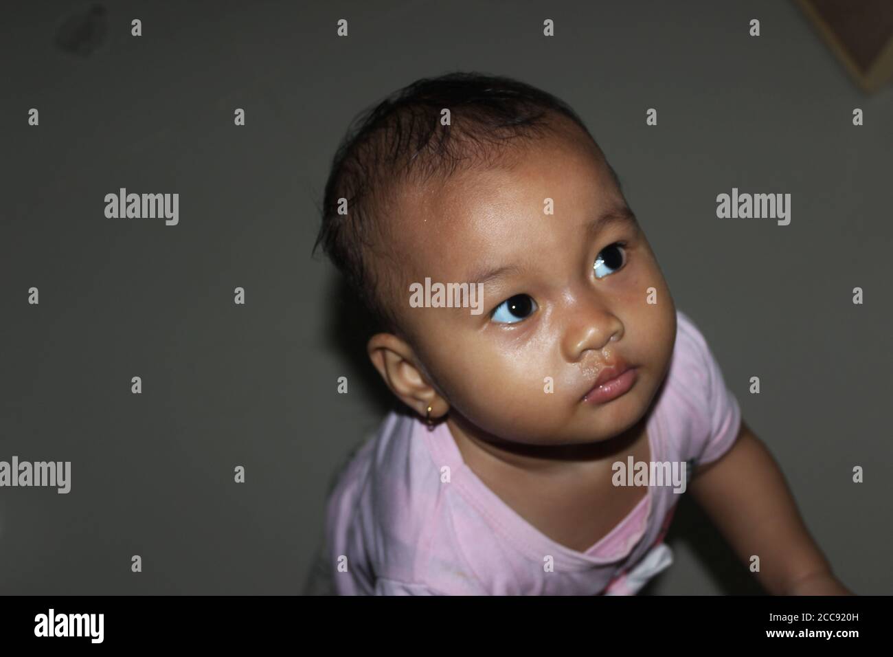 A cute beautiful Indonesian baby girl playing in the house Stock Photo ...