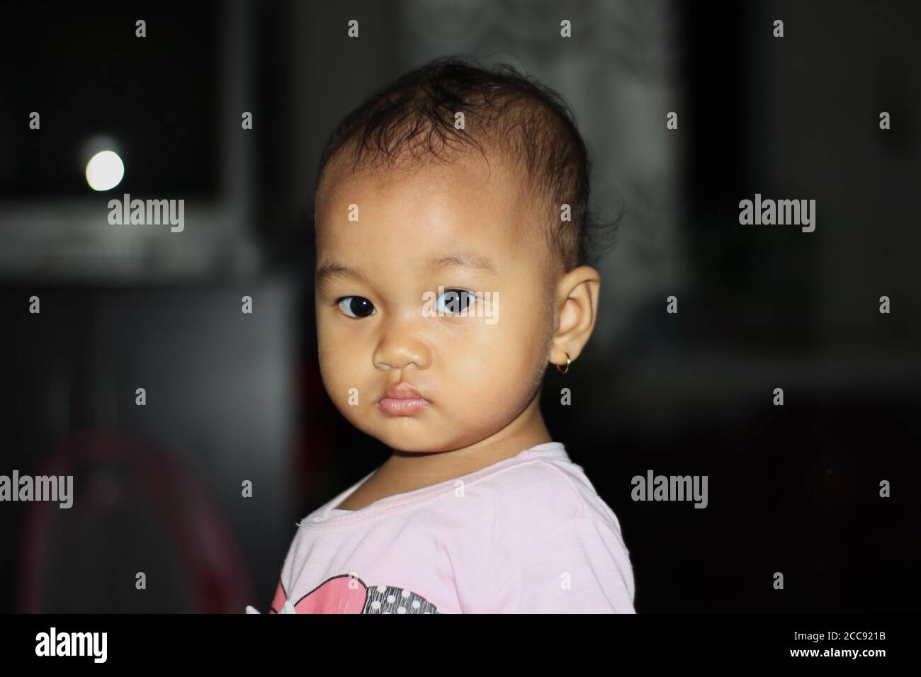 A cute beautiful Indonesian baby girl playing in the house Stock Photo ...