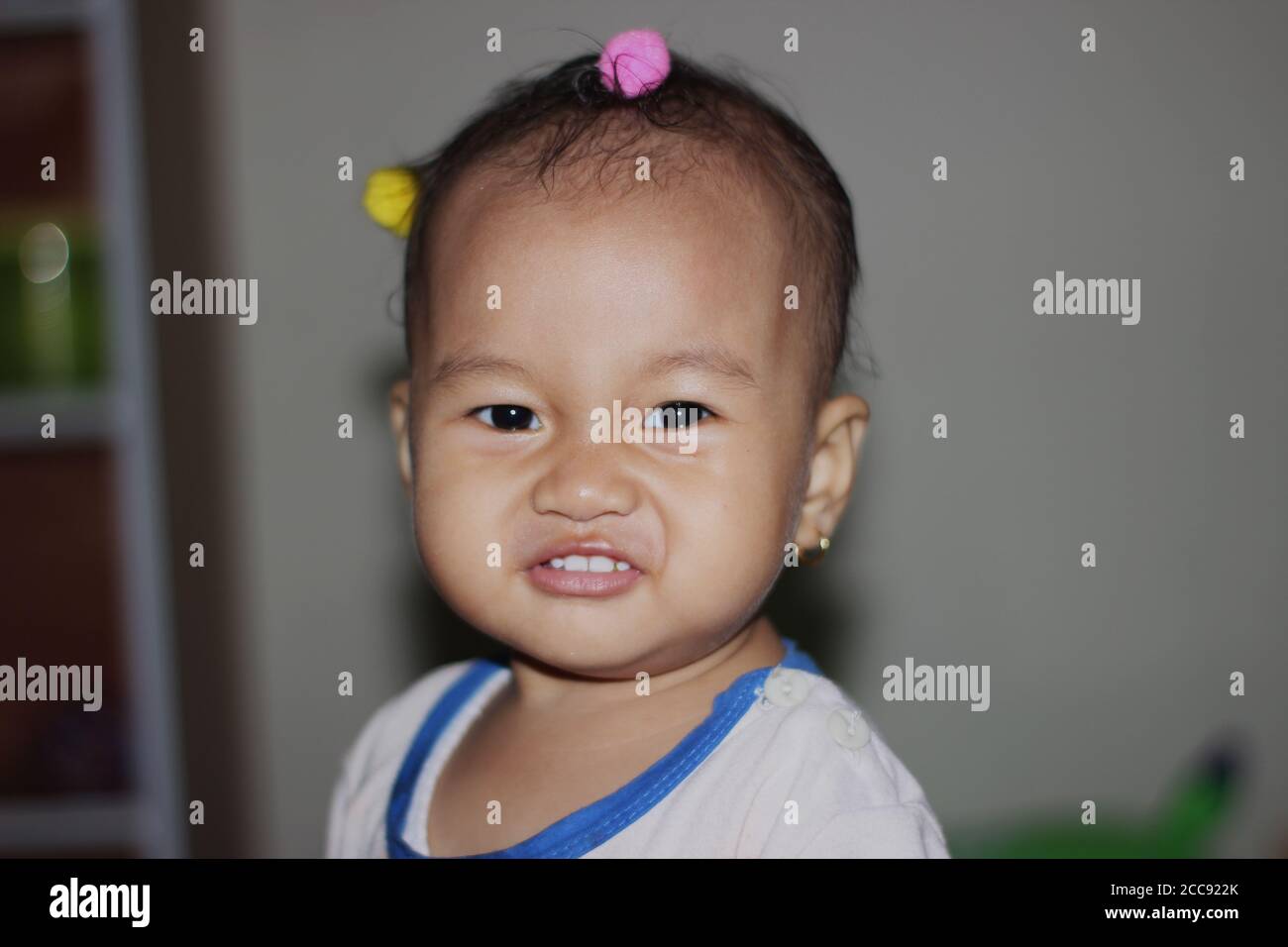 A cute beautiful Indonesian baby girl playing in the house Stock Photo ...