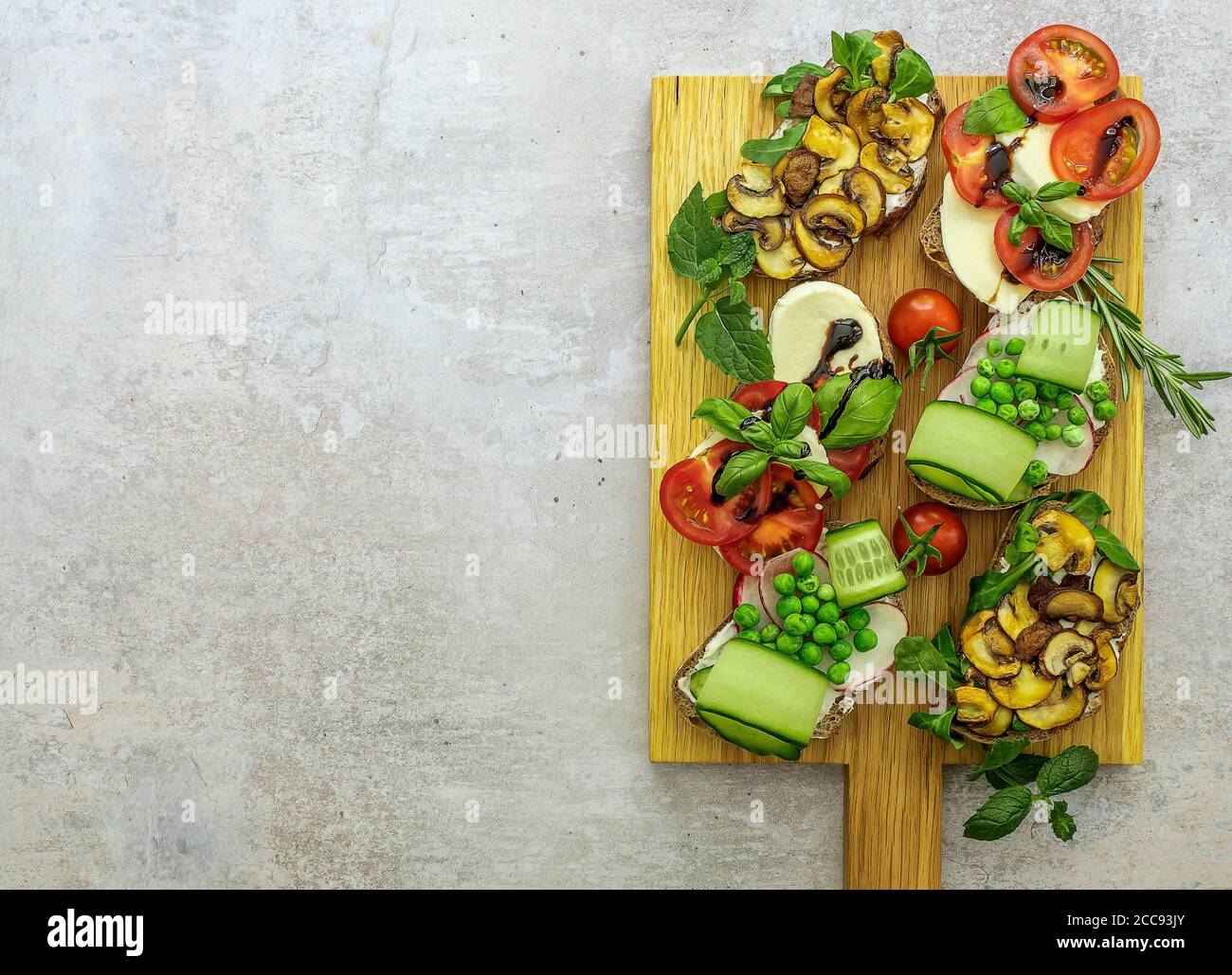 Great vegetarian appetizers with different toppings, top view. Flat lay ...