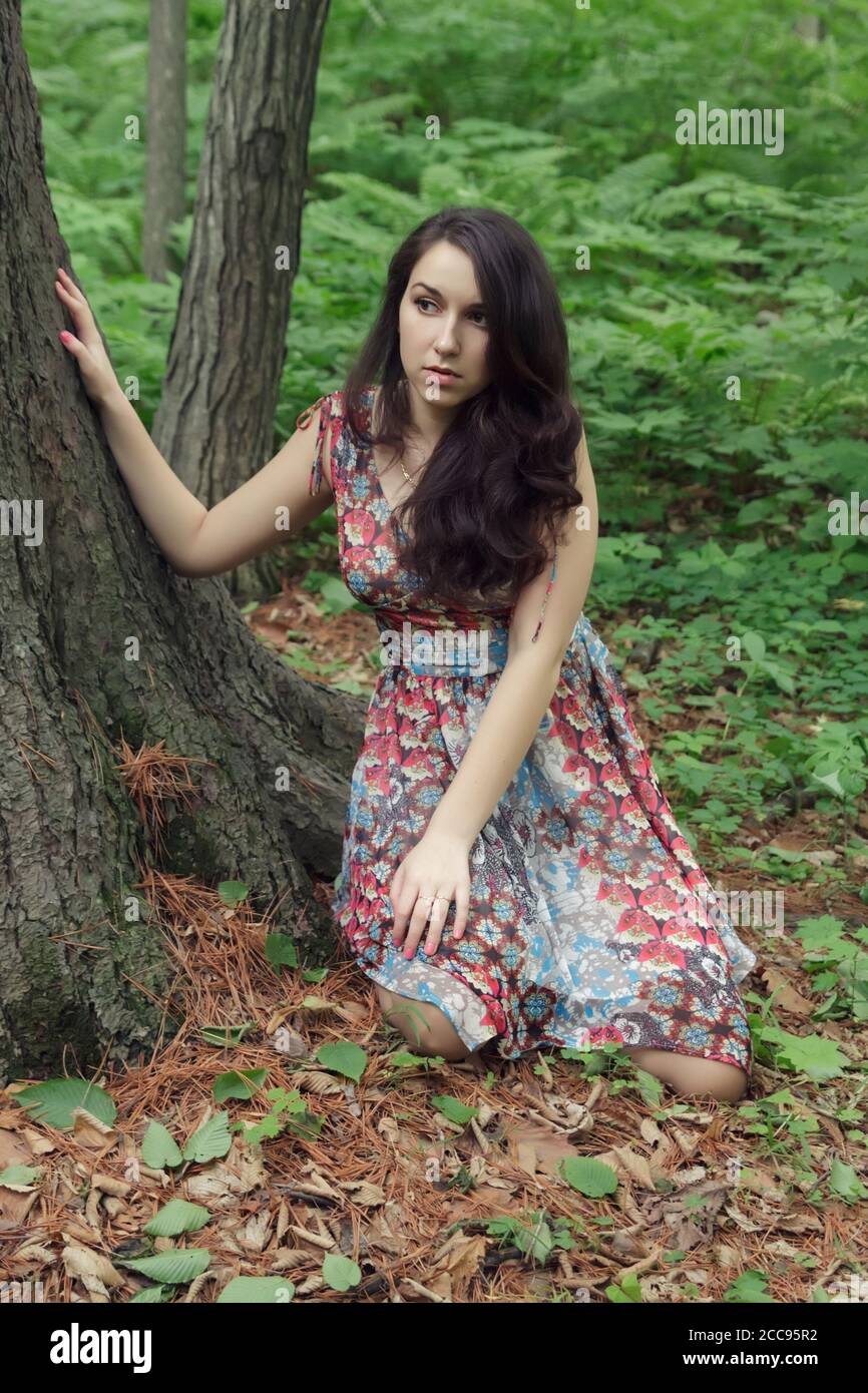 Scared young woman a forest at night Stock Photo - Alamy