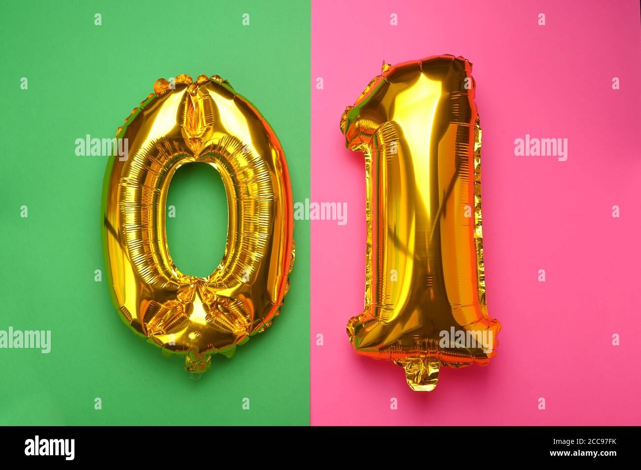 Numbers 01. Gold balloons on a pink and green background. Birthday and ...