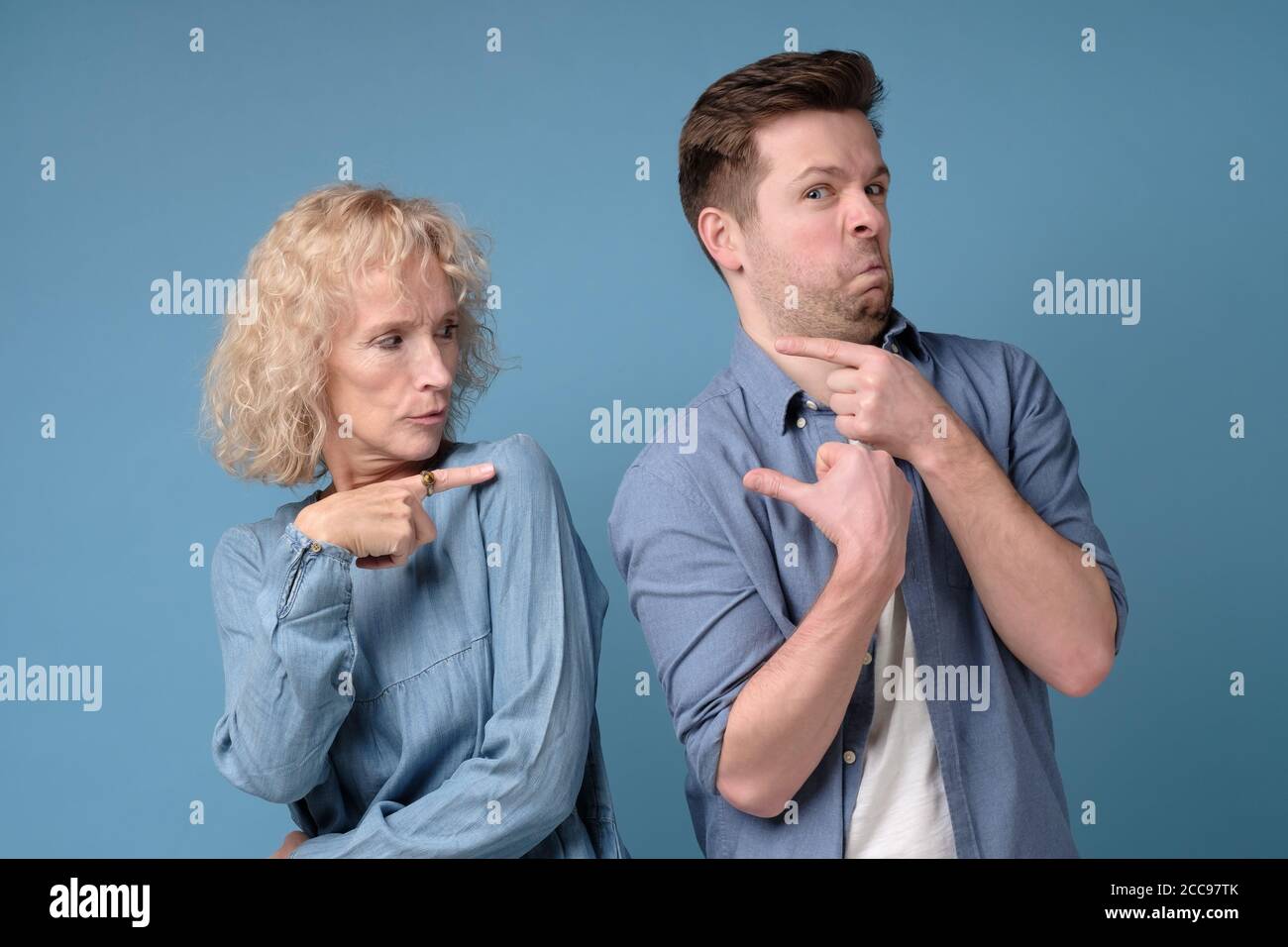 Woman and man pointing fingers at each other, blaming each other for ...