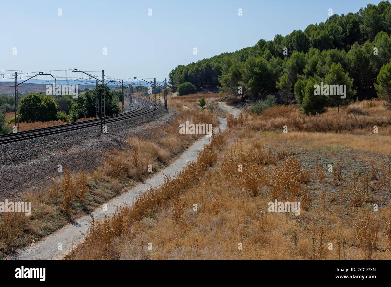 A train track through the agricultural fields in the outskirts of ...