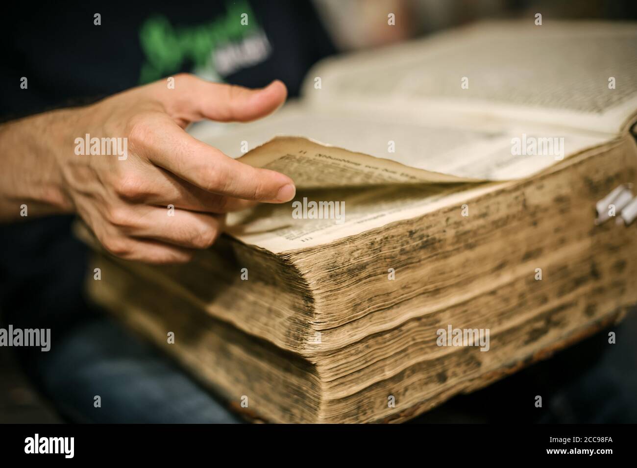 Curious man reading old book in his library at home. Retro style Stock ...