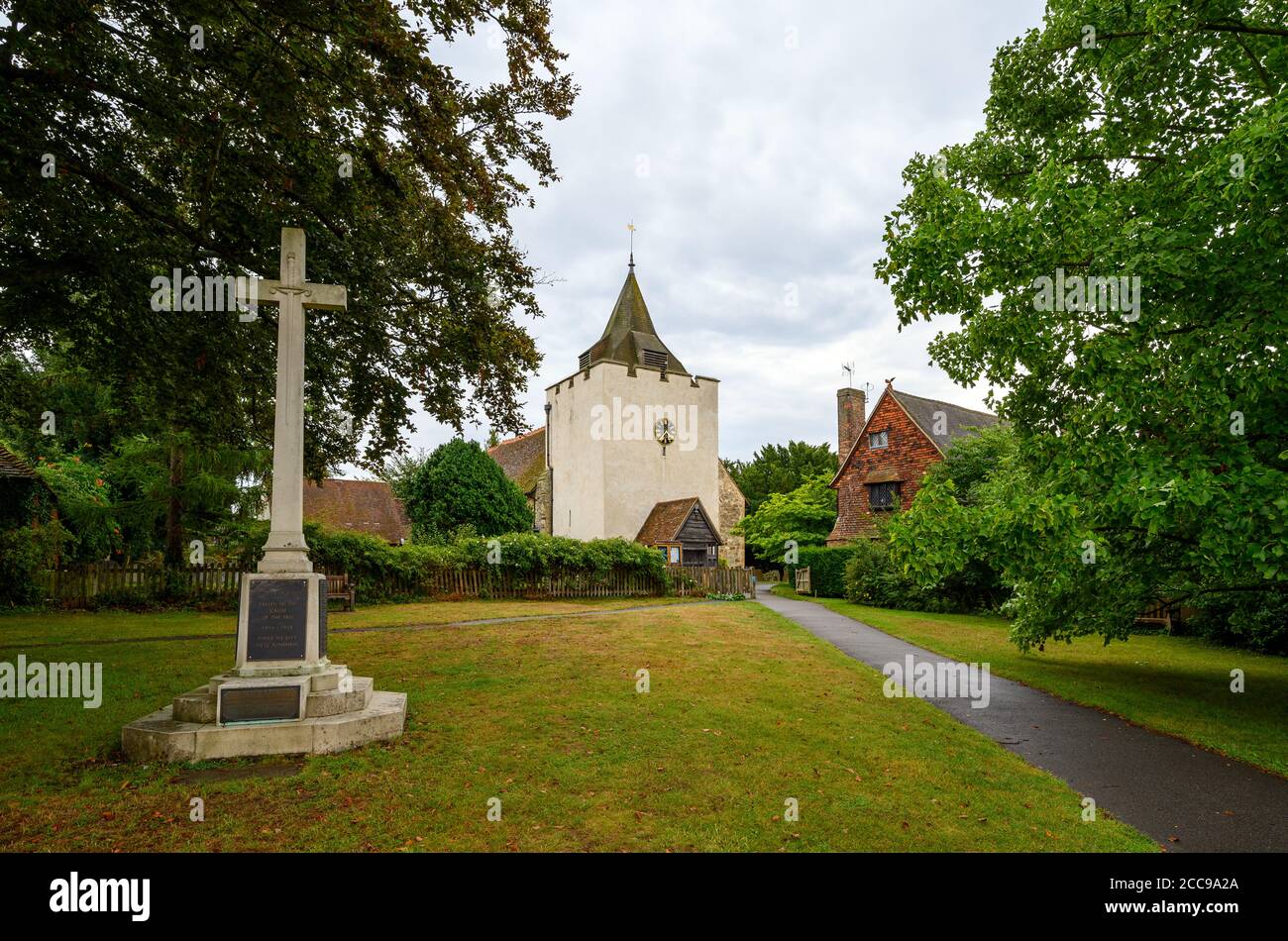 St Bartholomew's Church in Otford, Kent, UK with war memorial. The ...