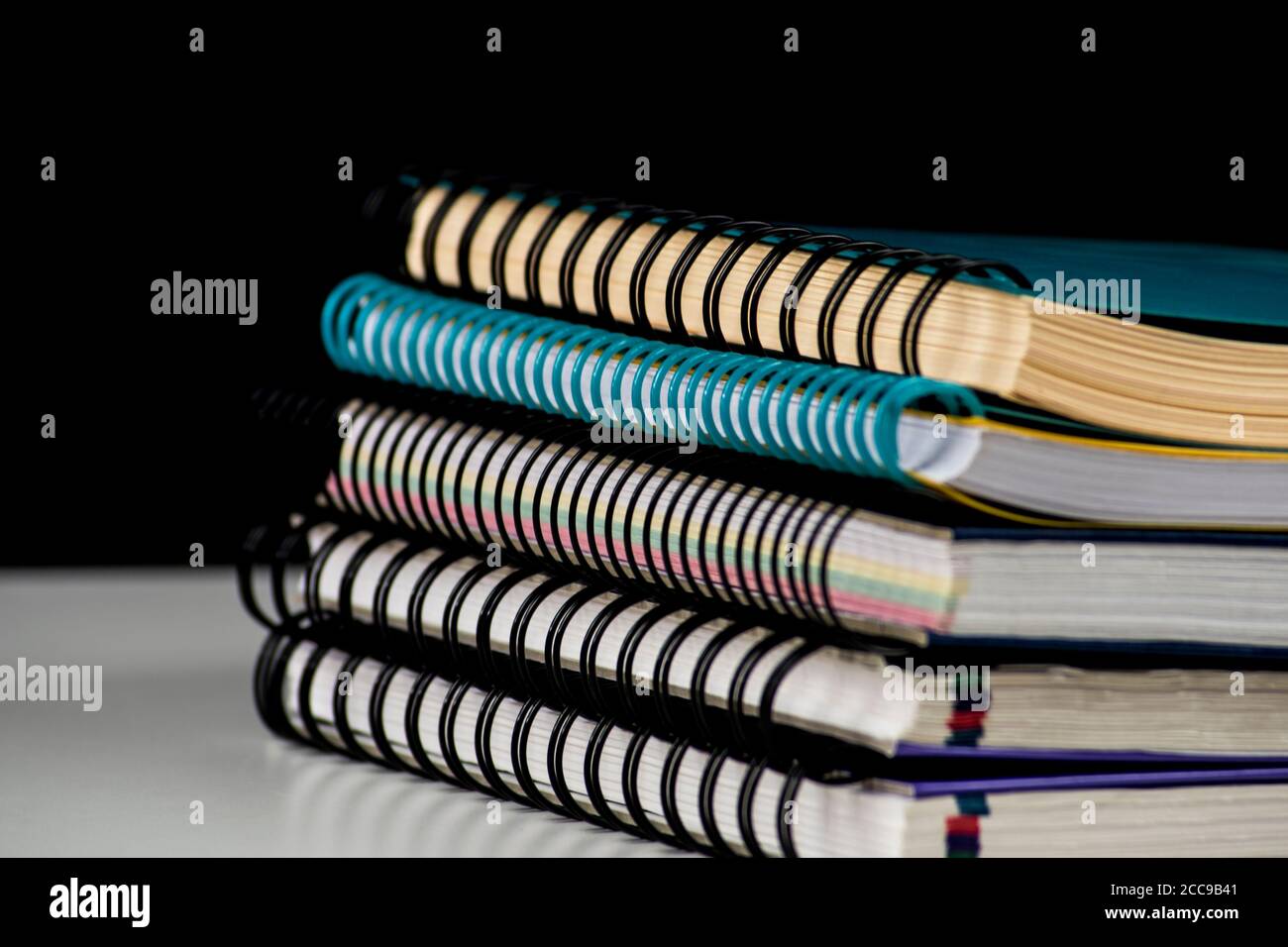 pile of spiral wire notebooks Stock Photo - Alamy