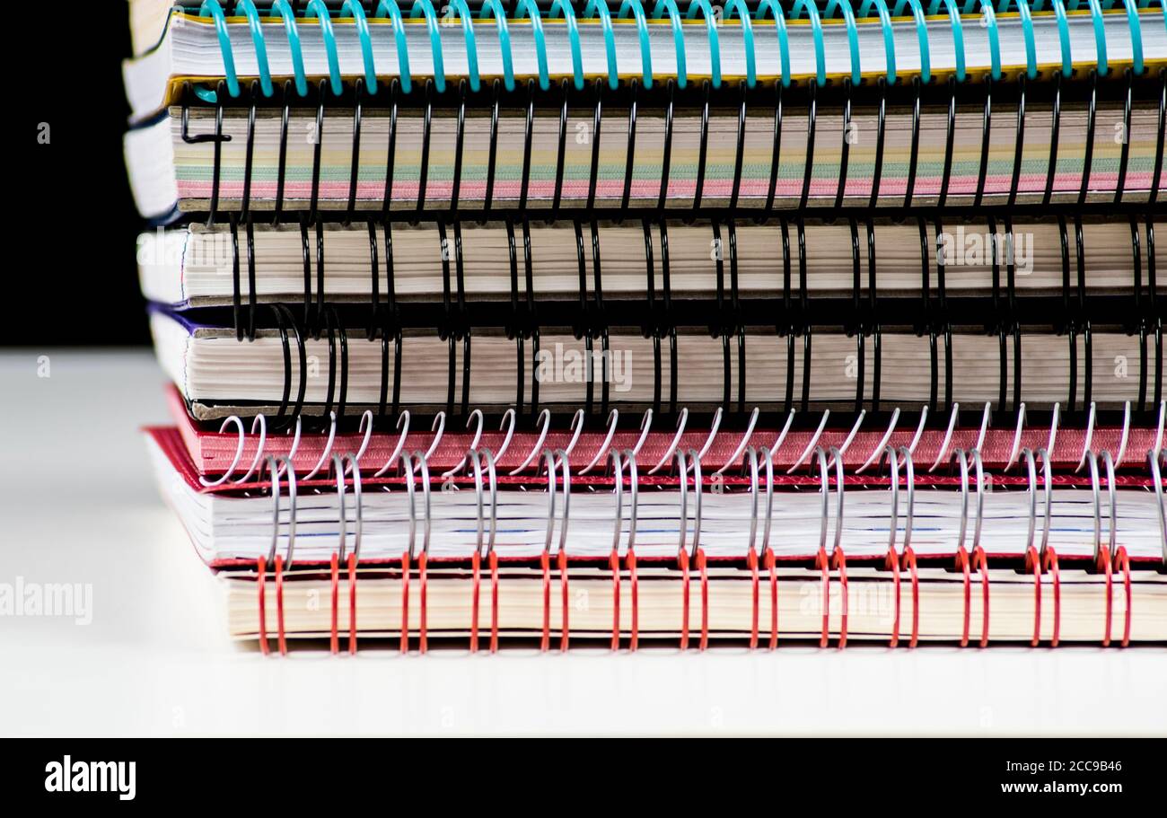 pile of spiral wire notebooks Stock Photo - Alamy