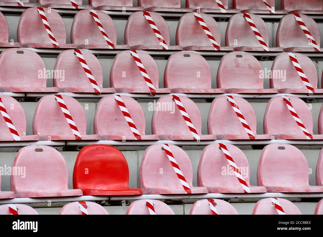 Partially faded red seats in the Franz Kremer Stadium. Prepared with ...