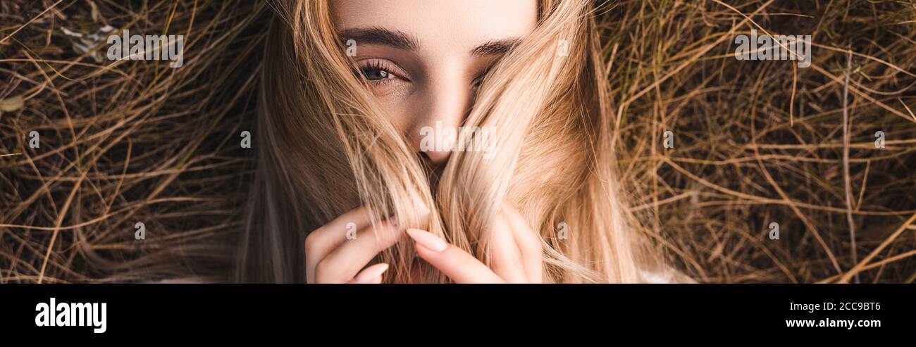 horizontal image of sensual blonde woman lying on green grass and ...