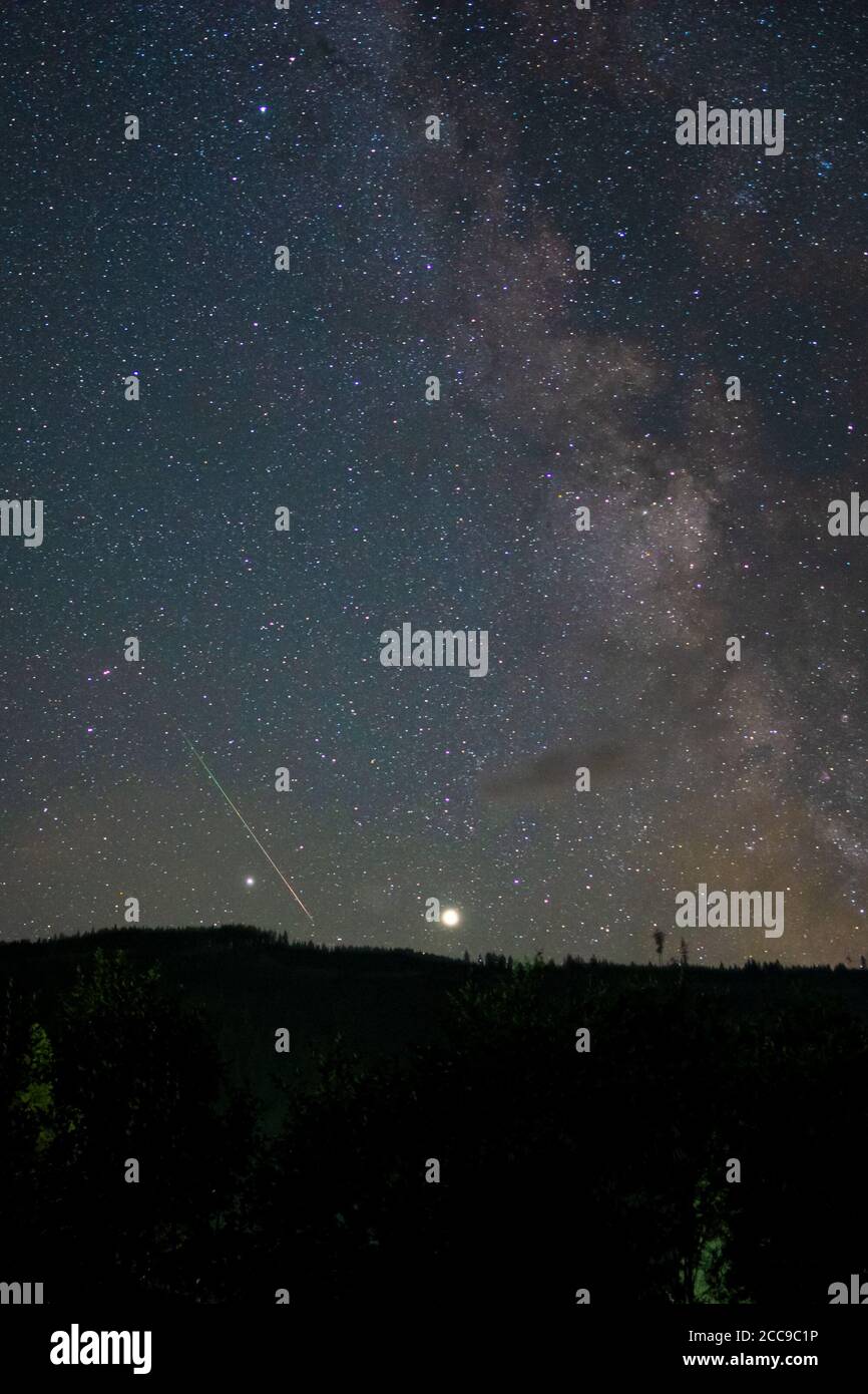 Meteor or falling star over the mountains of the Alps during the ...
