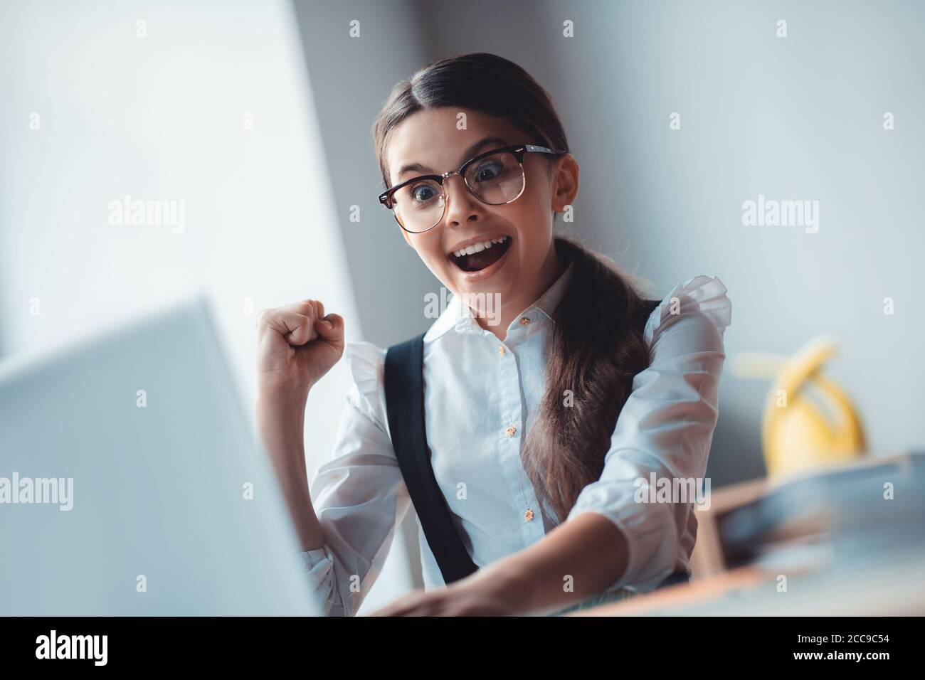 Cute brunette girl in eyeglasses feeling happy Stock Photo - Alamy