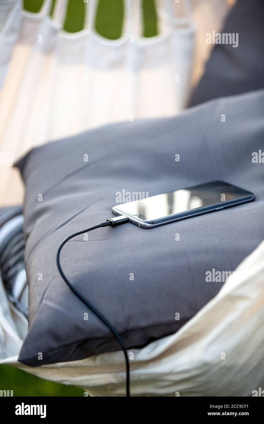 Smarth phone charging on the pillow in hanging nest Stock Photo - Alamy