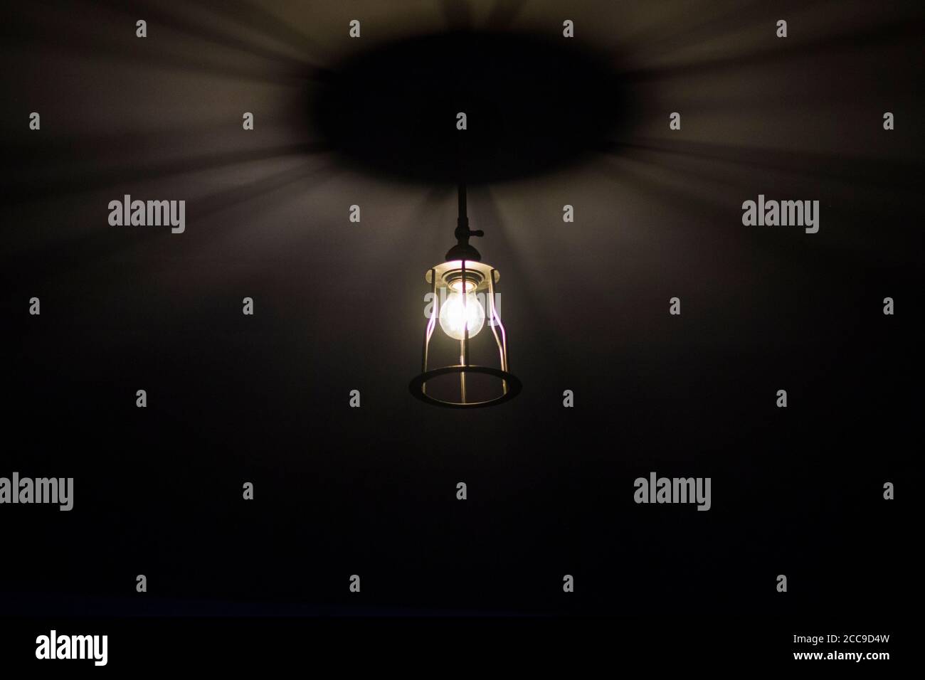 Bulb and lamp on the ceiling, dark and light, shadows and lights ...