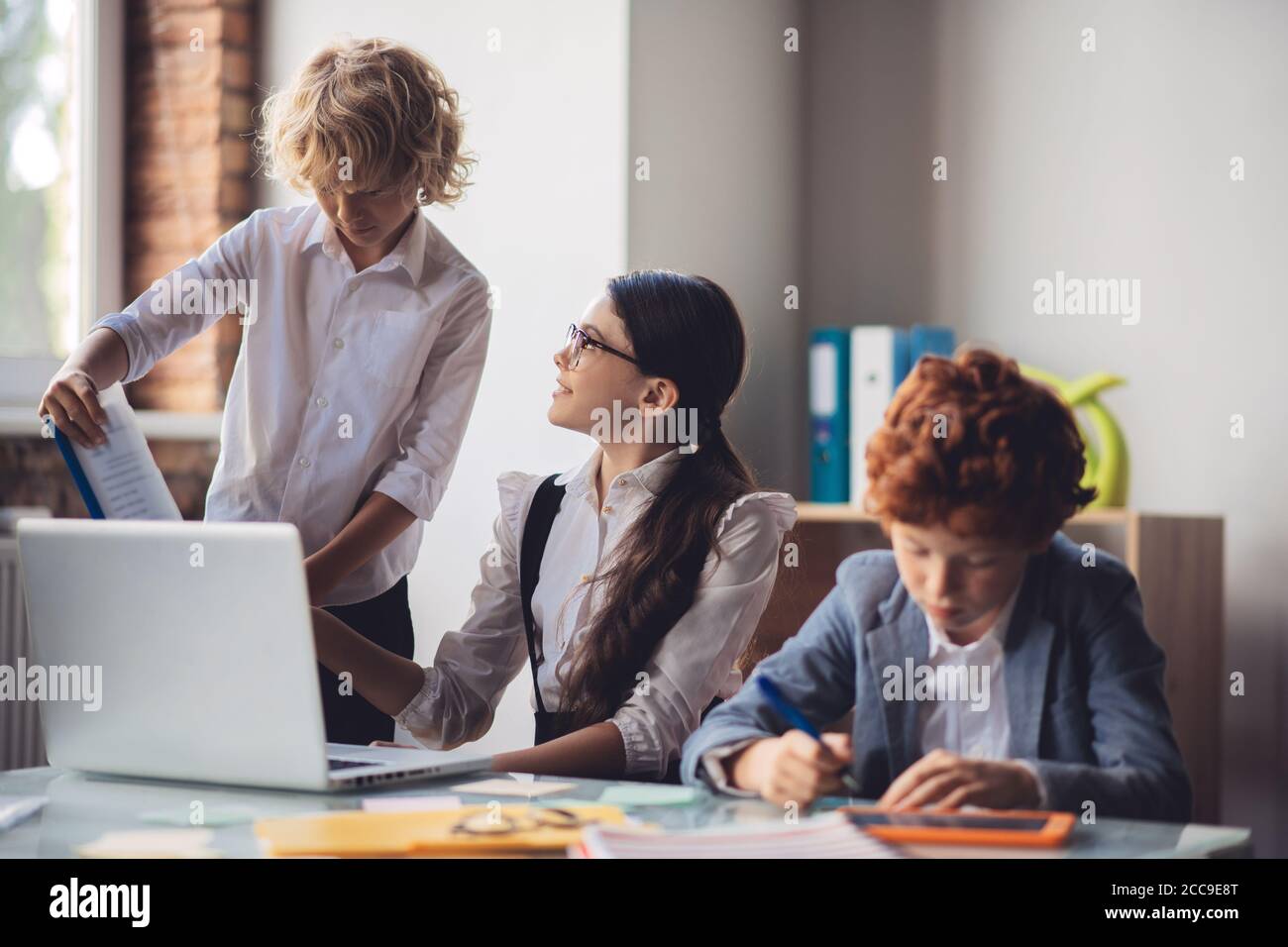 Three classmates working on a project together Stock Photo - Alamy