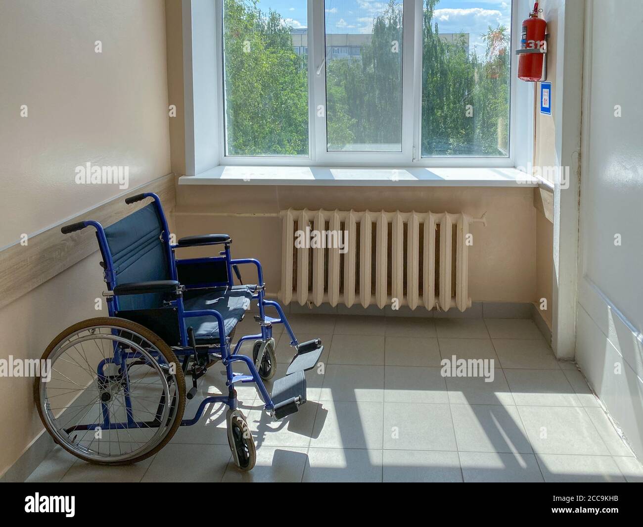 Wheelchair in the corridor of the hospital on the window background ...
