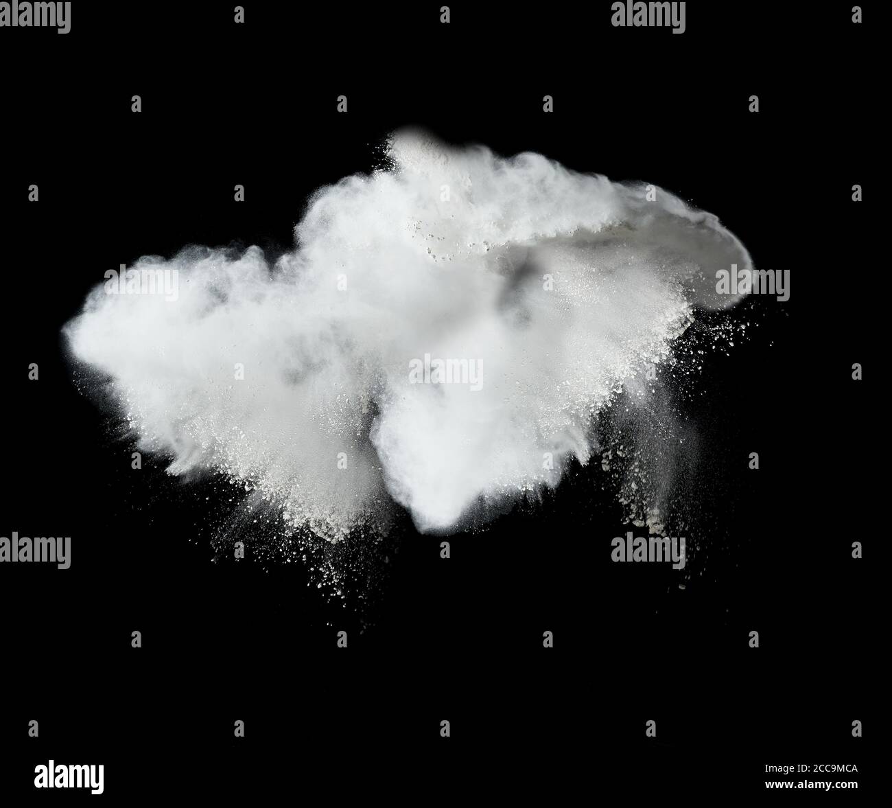 cloud of white wheat flour on a black background, particles fly in ...