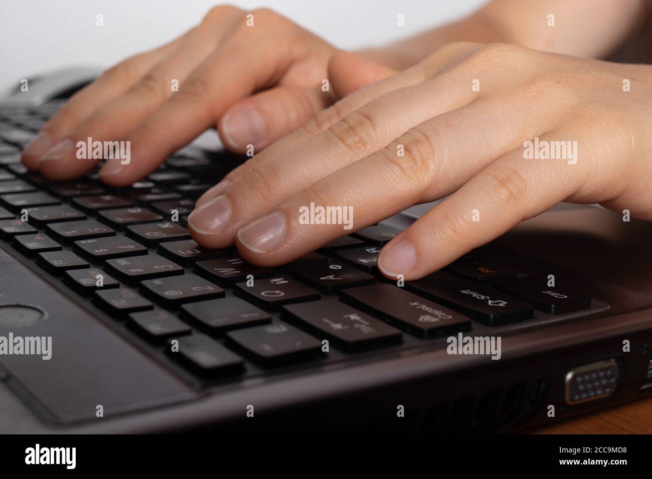 Human hands are typing text on a black laptop keyboard Stock Photo - Alamy