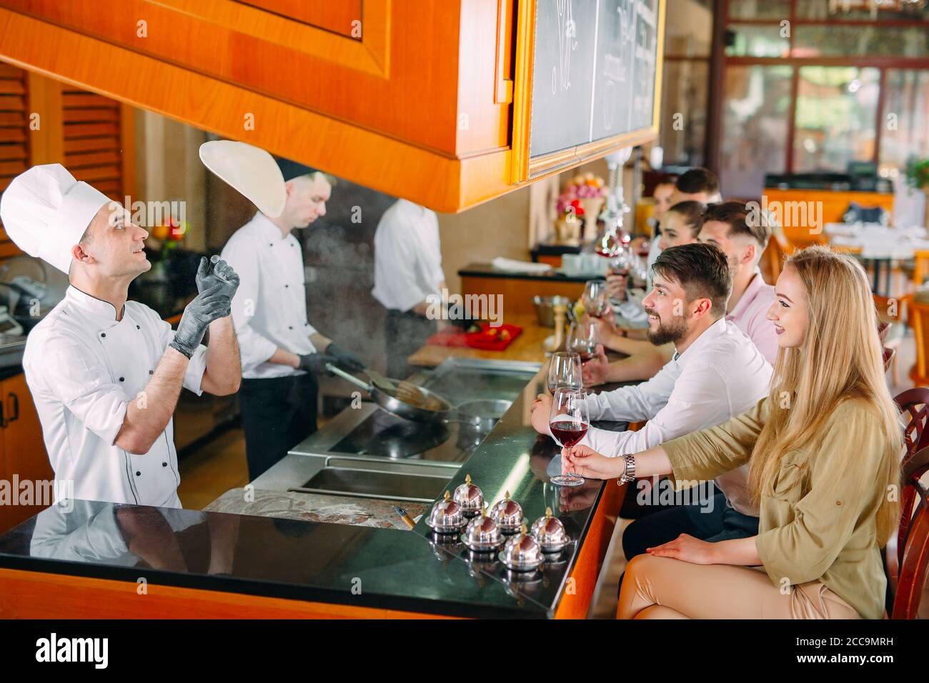 The chef prepares food in front of the visitors in the restaurant Stock ...