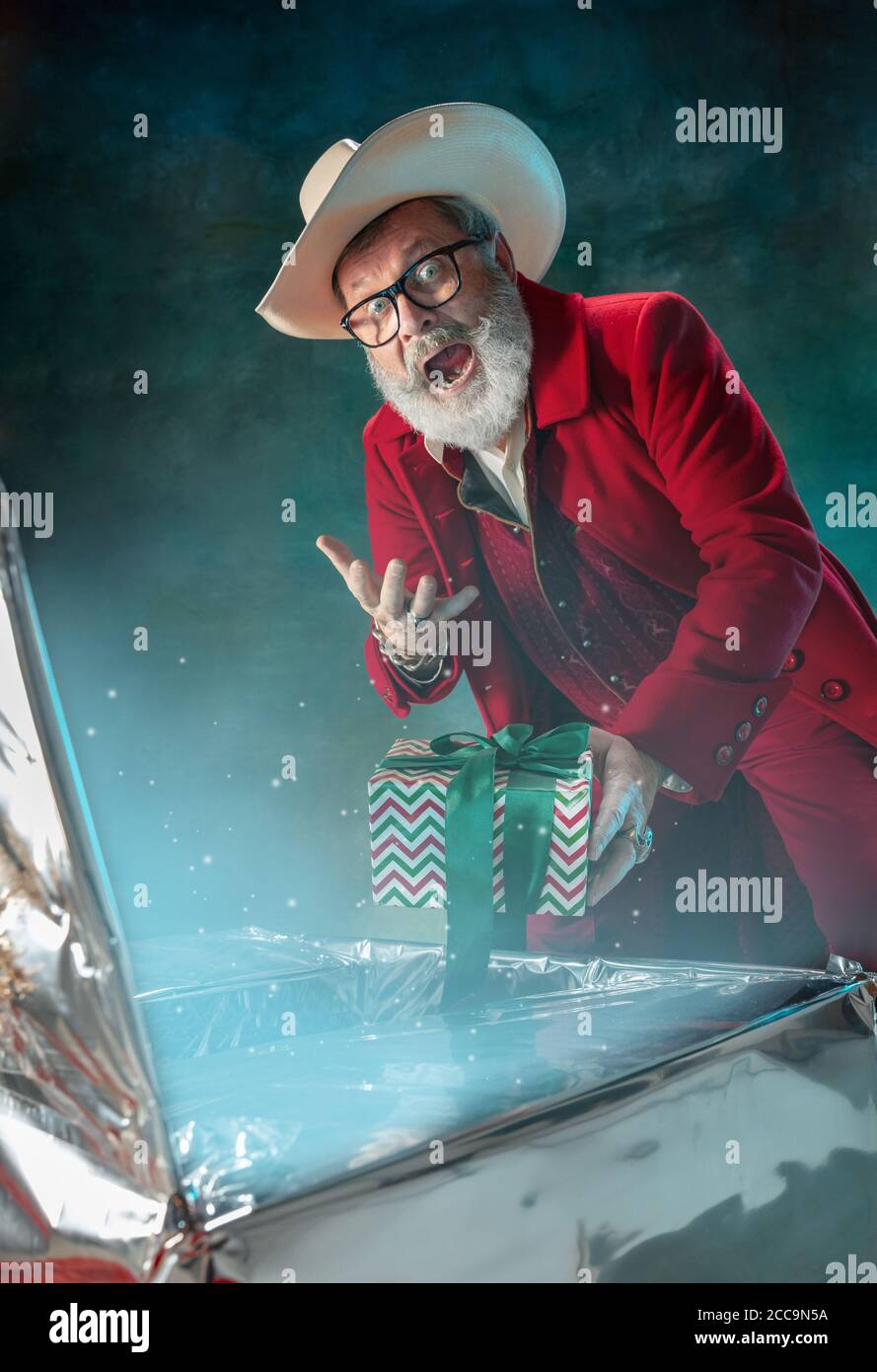 Gifts for 2021. Modern stylish Santa Claus in red fashionable suit and ...