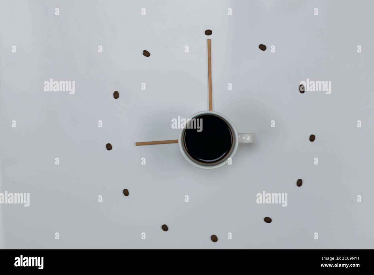Coffee beans clock with cup of coffee in center on white background ...