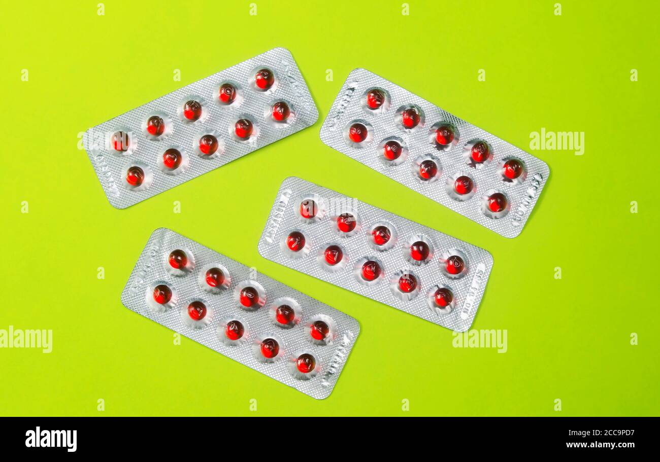 Metal drug blister with red medicine capsules Stock Photo - Alamy